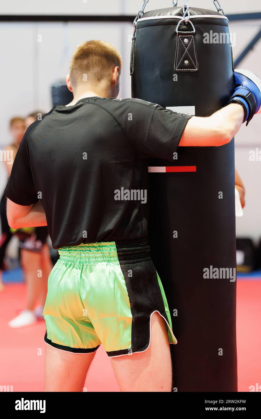 Boxer Holding Down the Training Bag for His Partner's Workout Session ...