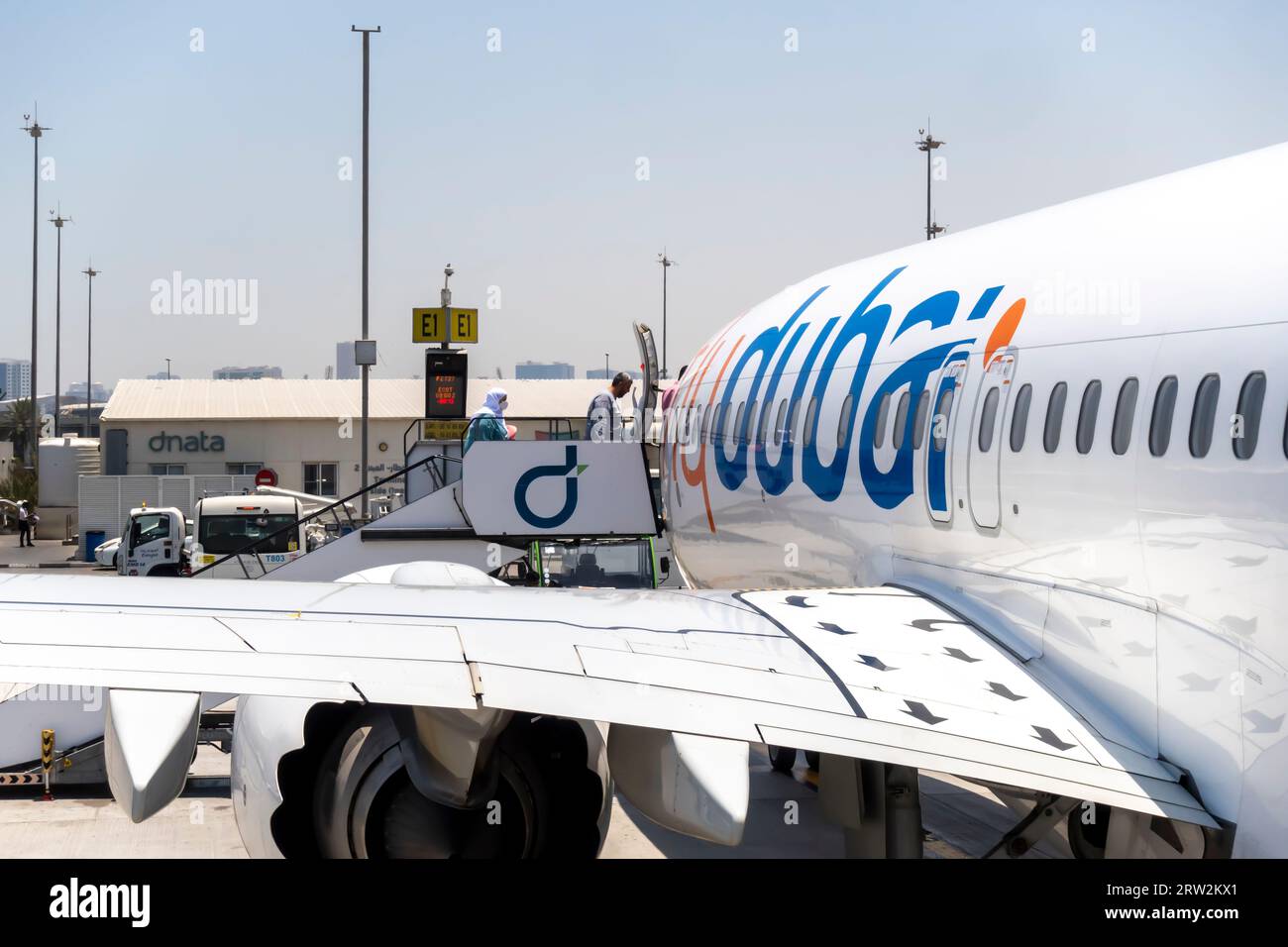 Passengers boarding airstairs to FlyDubai aircraft in Dubai Airport ...