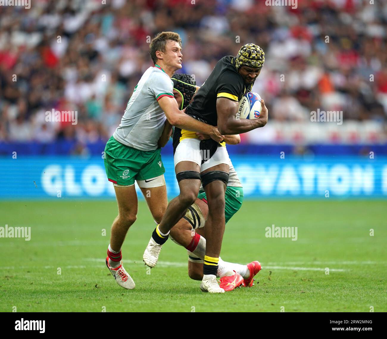 Wales' Christ Tshiunza tackled by Portugal's Jeromino Portela and ...