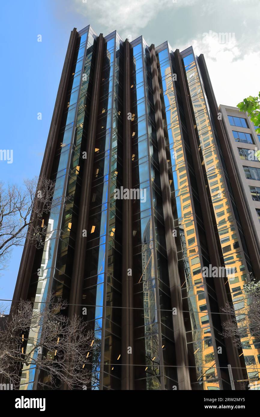 944 Saw toothed curtain wall facade of gold tinted office tower on ...