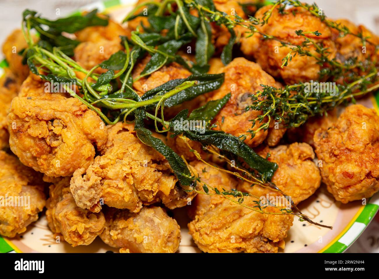 Traditional fried chicken with aromatic herbs, thyme and sage. Tabasco ...
