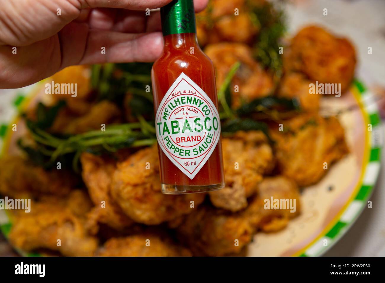 Traditional fried chicken with aromatic herbs, thyme and sage. Tabasco ...