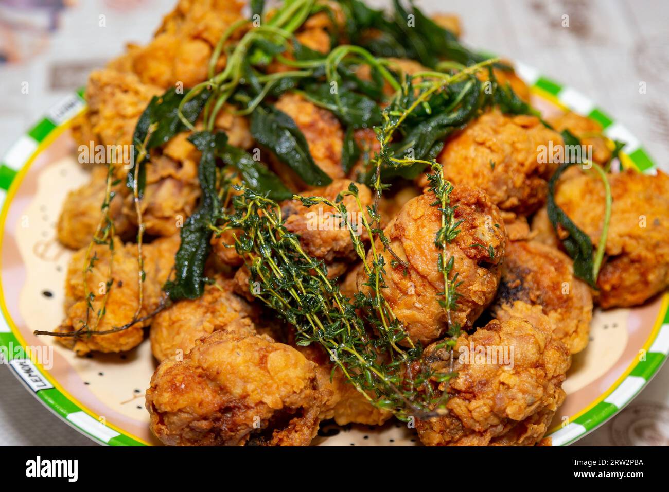 Traditional fried chicken with aromatic herbs, thyme and sage. Tabasco ...
