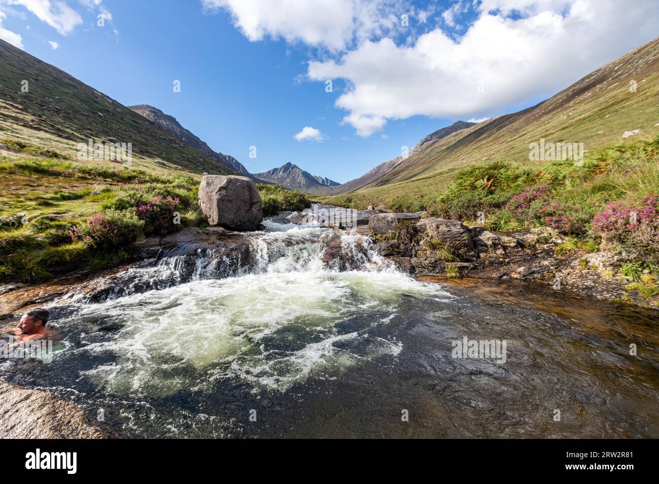 Tourist having a bath in Blue Pools Glenrosa waters, Glen Rosa, Goat ...