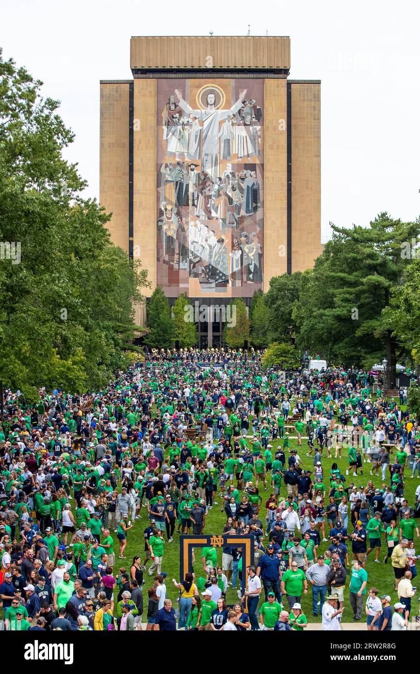 Notre Dame fans walk in a quad in front of the Touchdown Jesus mural on ...
