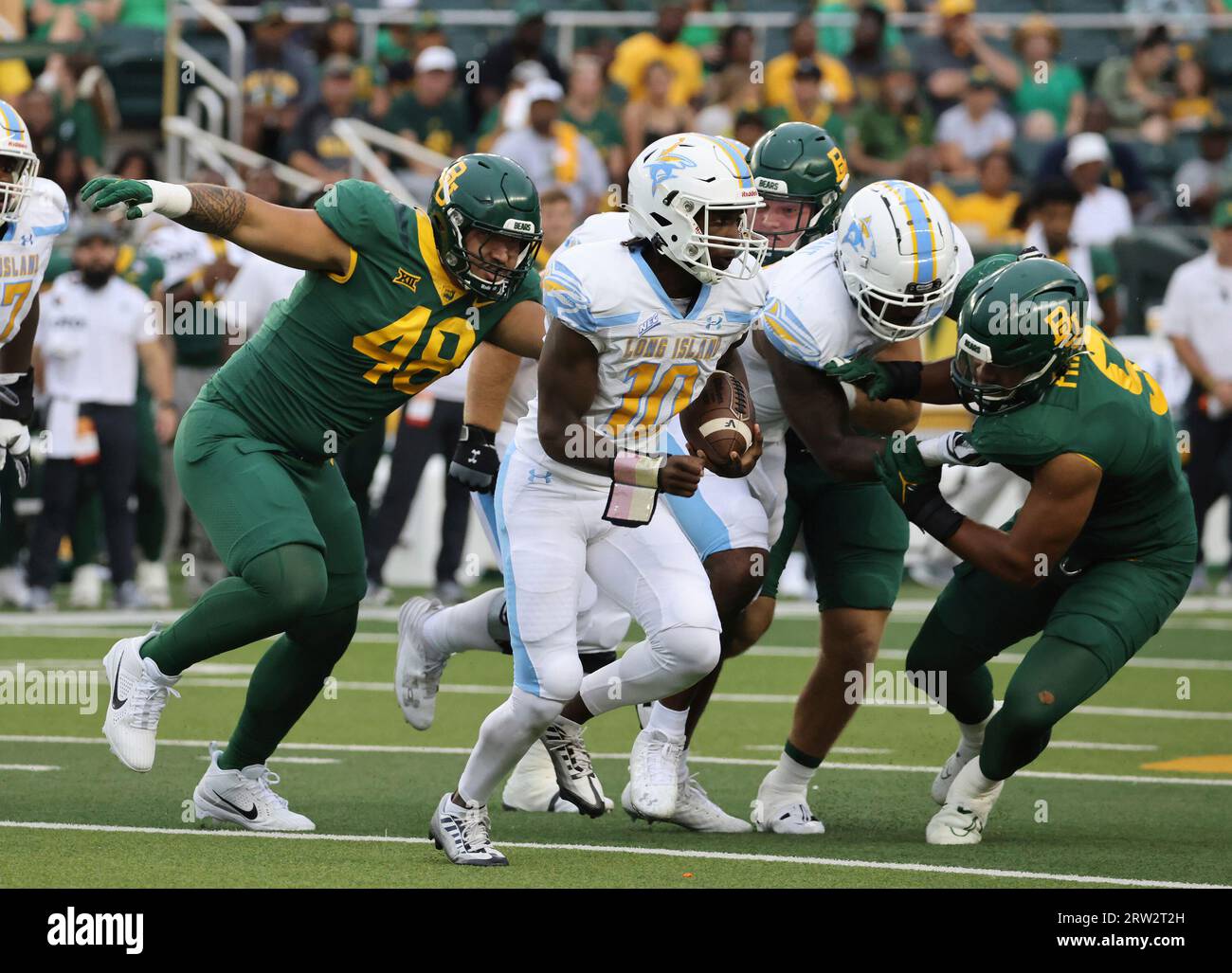 Long Island quarterback Chris Howell runs out of the pocket while ...