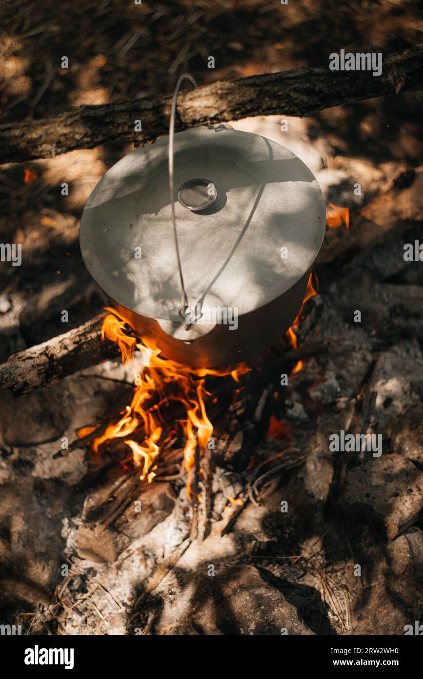 Pot hanging over camp fire hi-res stock photography and images - Alamy