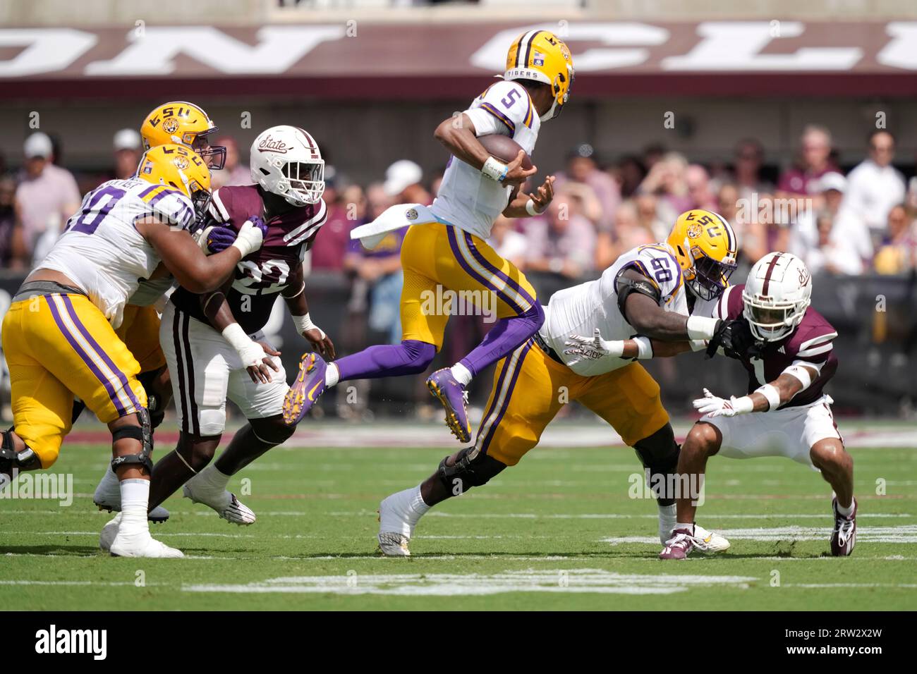 LSU quarterback Jayden Daniels (5) leaps into the air as he attempts to ...