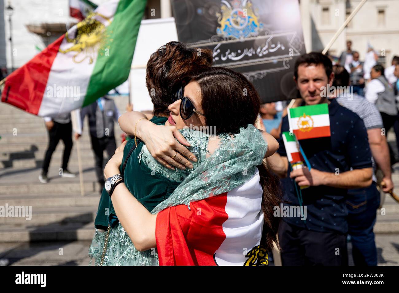 London, UK. 16th Sep, 2023. Iranian protesters are seen hugging each ...