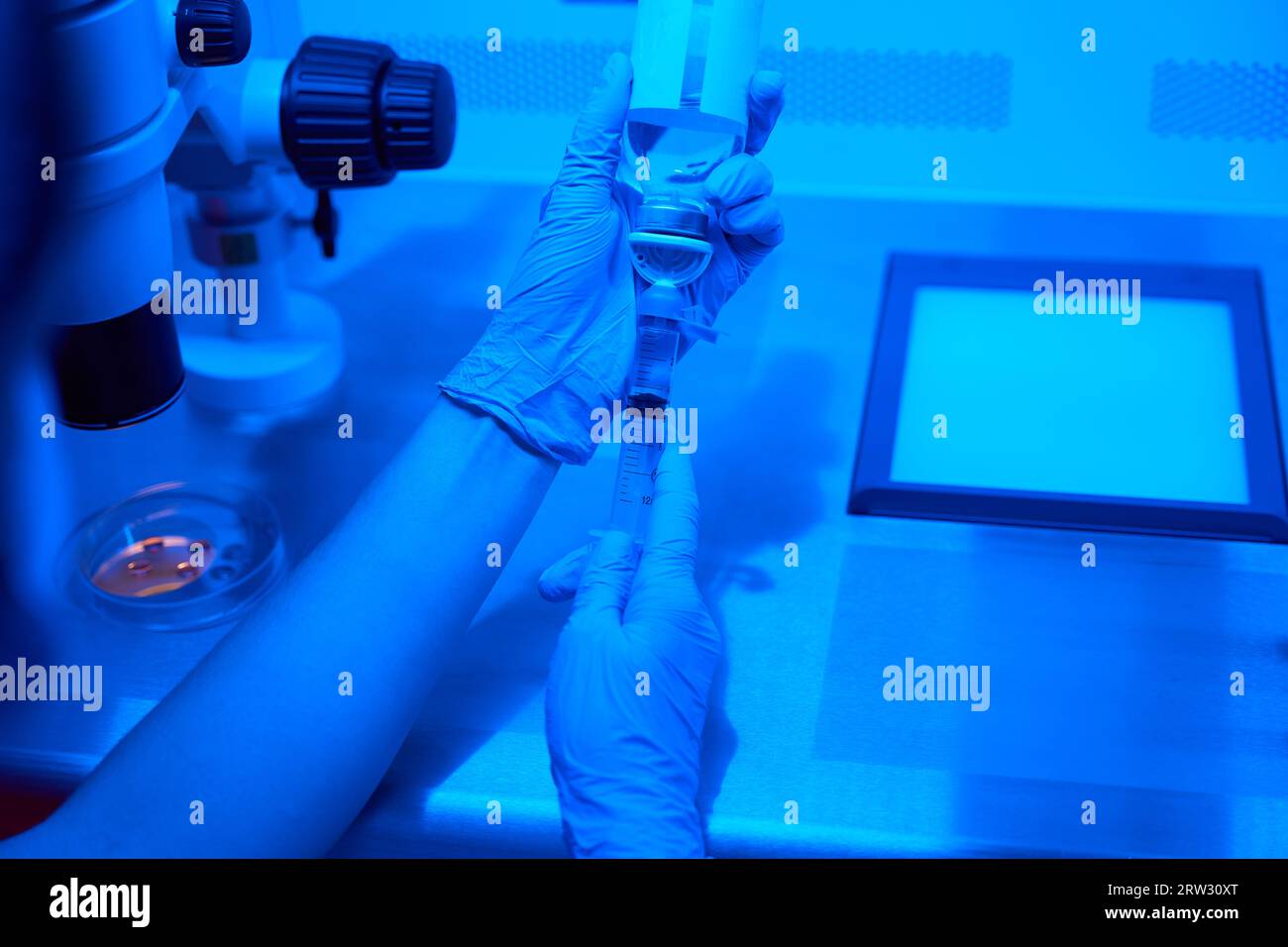 Laboratory employee conducts preparatory manipulations for the ICSI ...