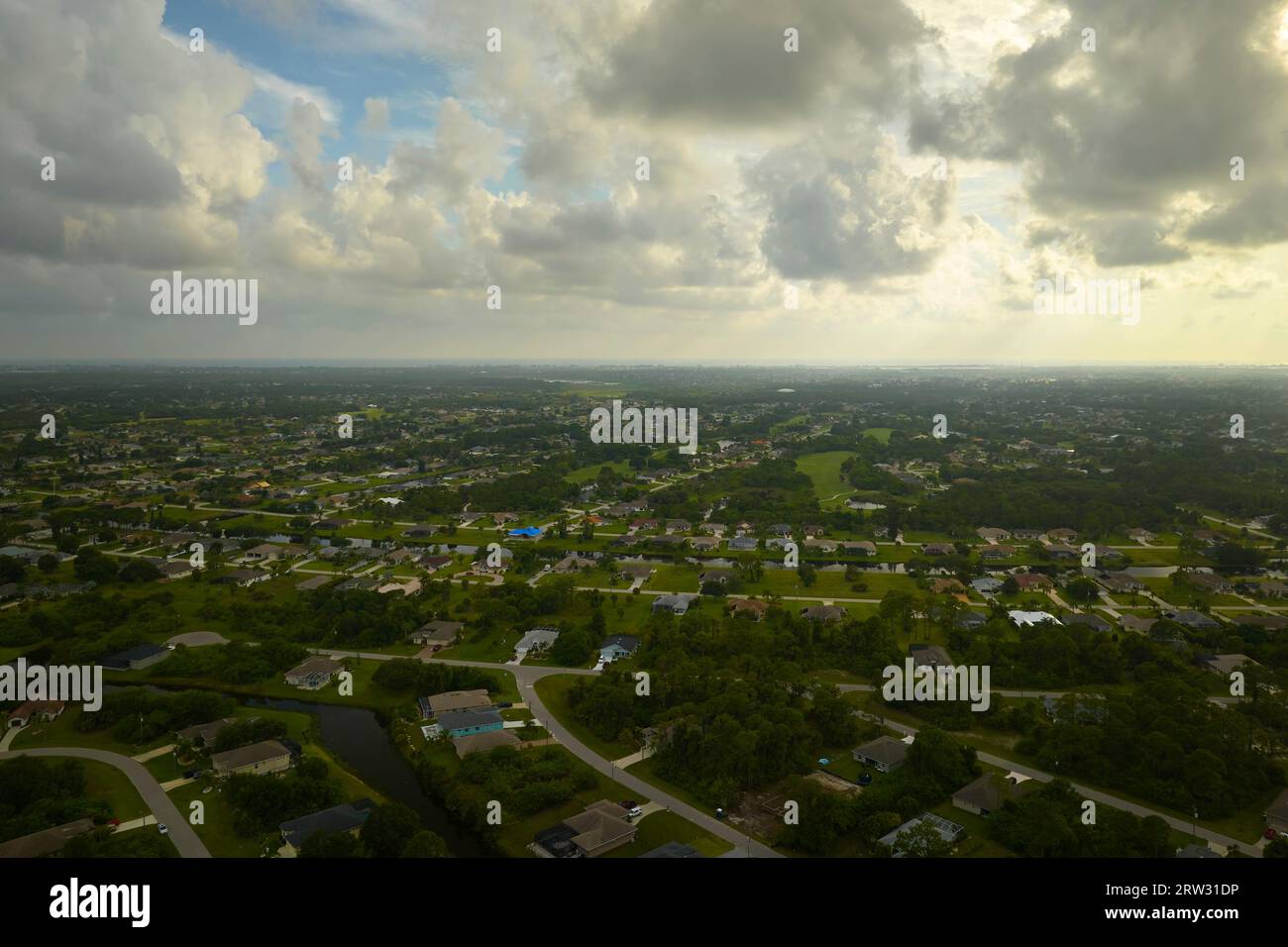 Aerial landscape view of suburban private houses between green palm ...