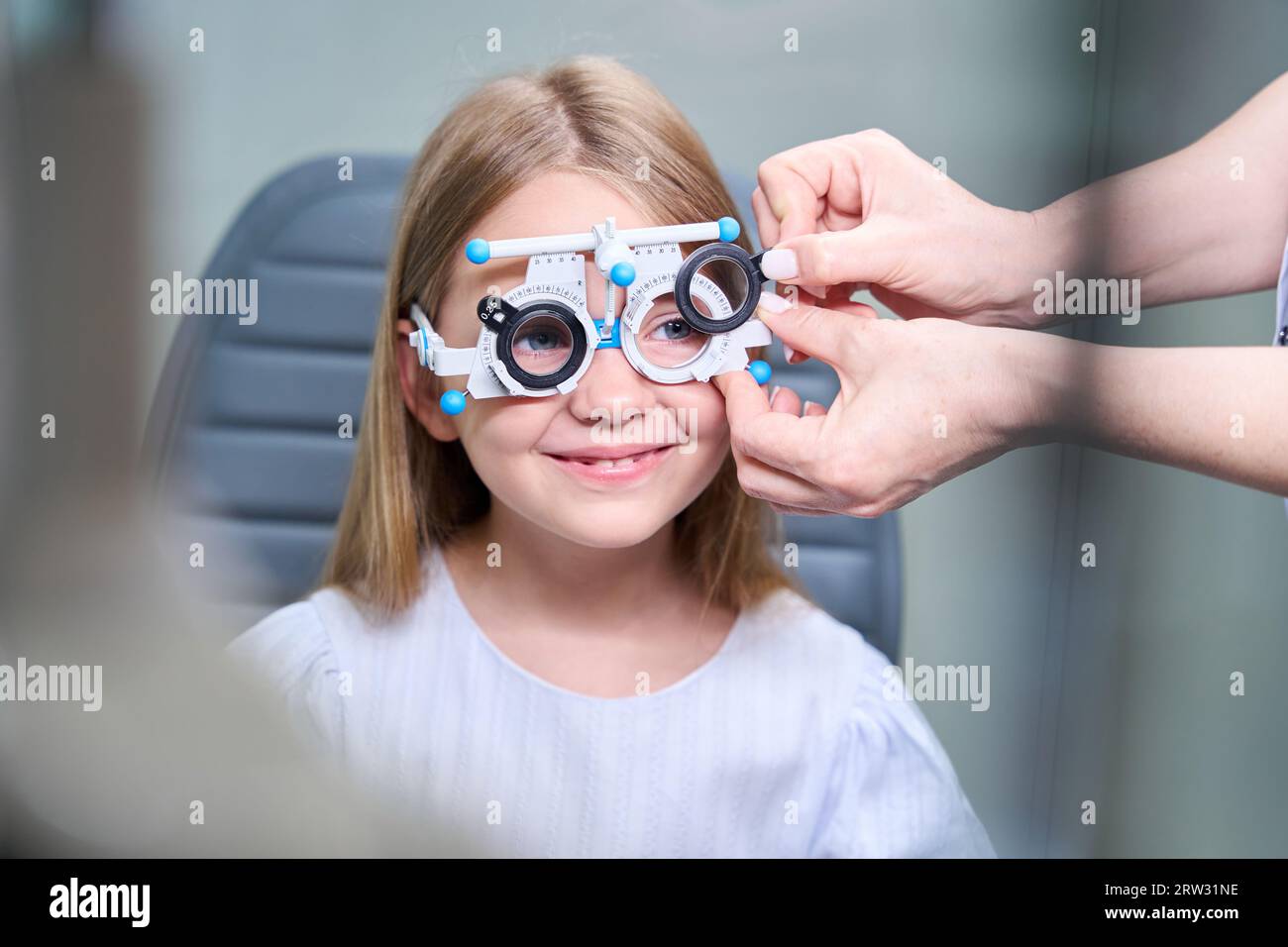 Qualified ophthalmologist performing subjective refraction test on ...