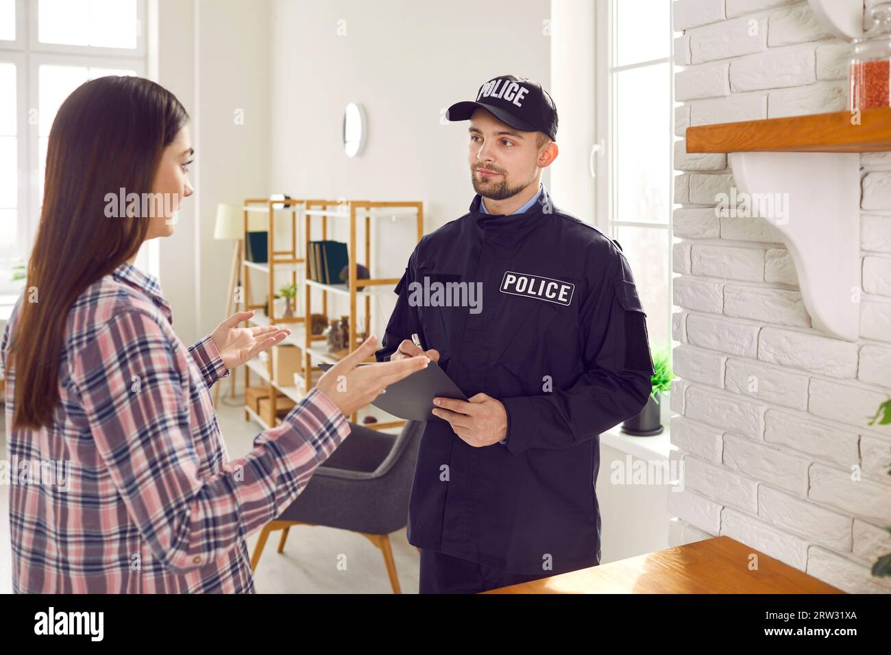 Policeman interviewing female victim after breaking into home Stock ...