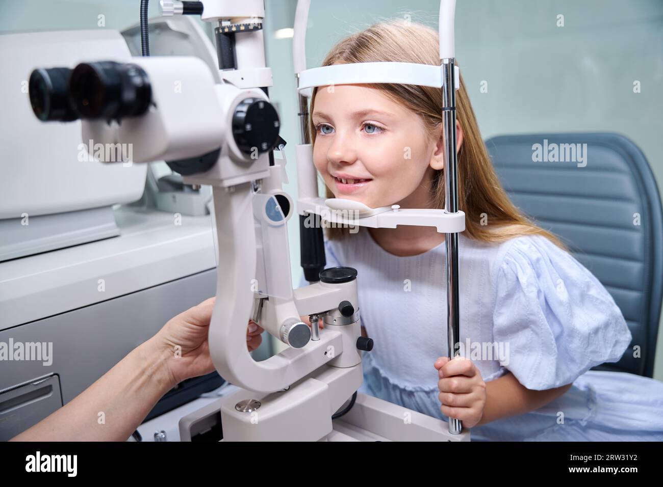 Child undergoing ophthalmic examination at eye clinic done by ...