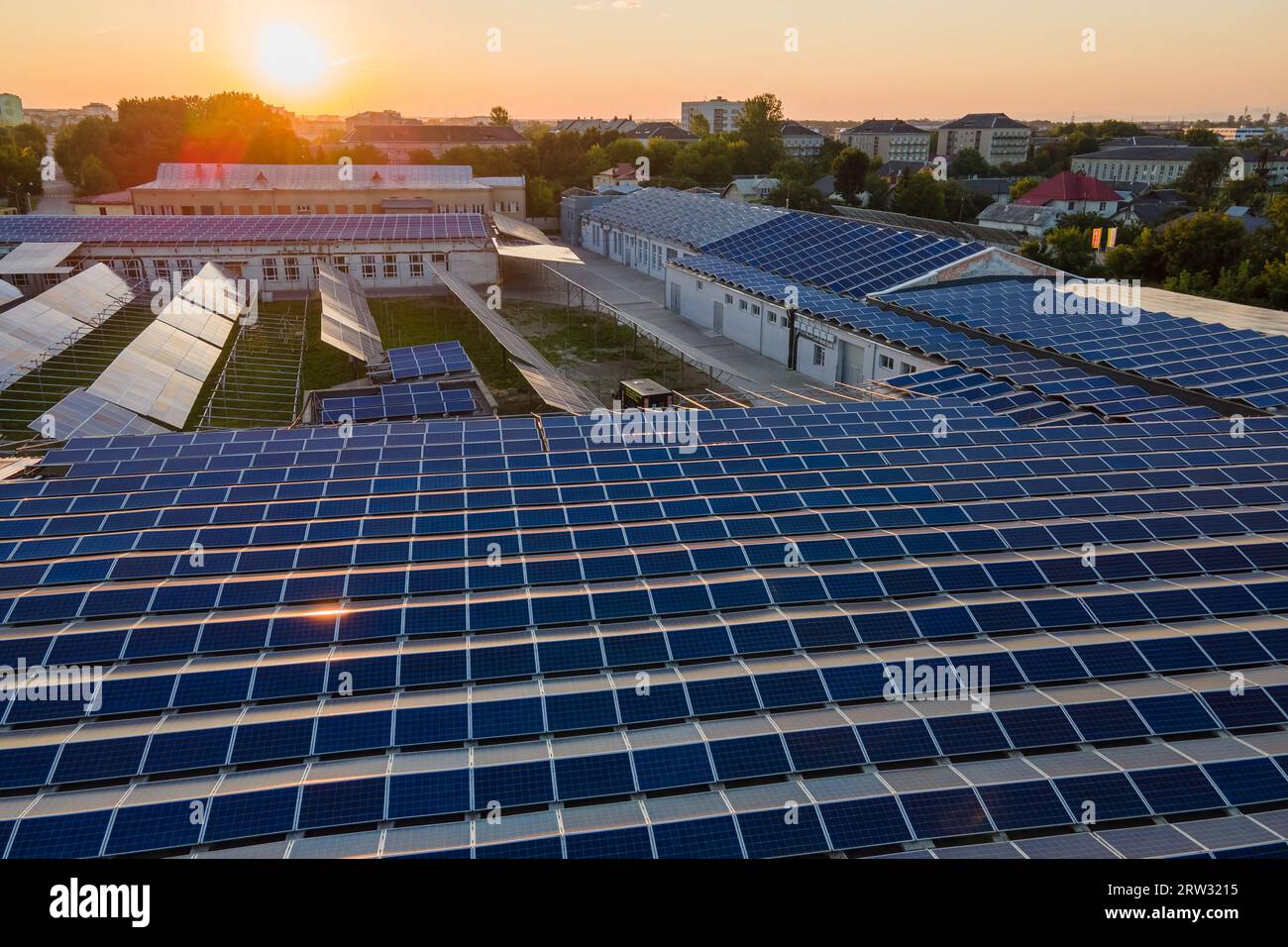 Aerial view of blue photovoltaic solar panels mounted on industrial ...