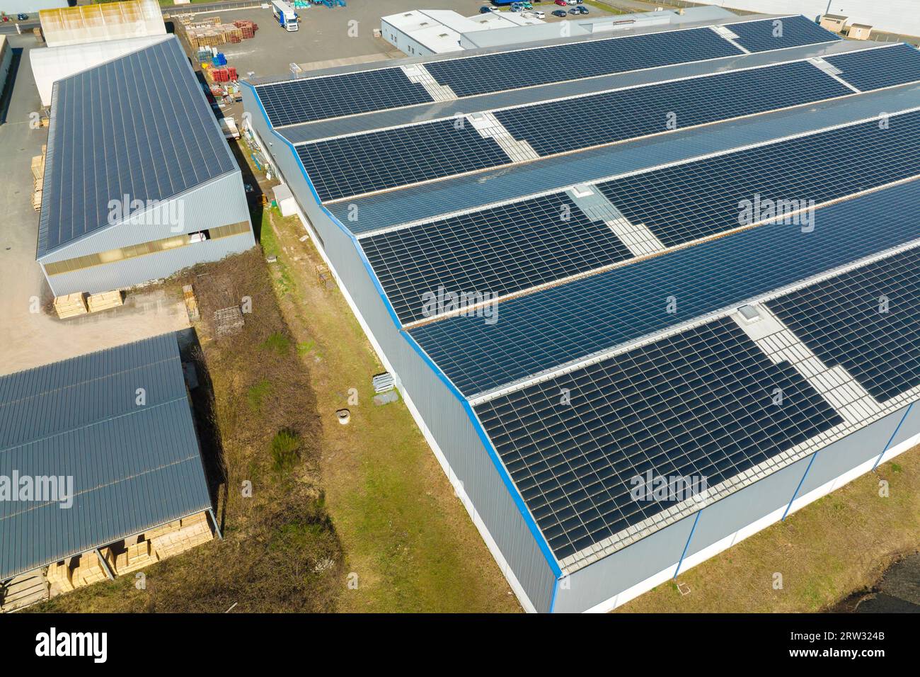 Aerial view of blue photovoltaic solar panels mounted on industrial ...