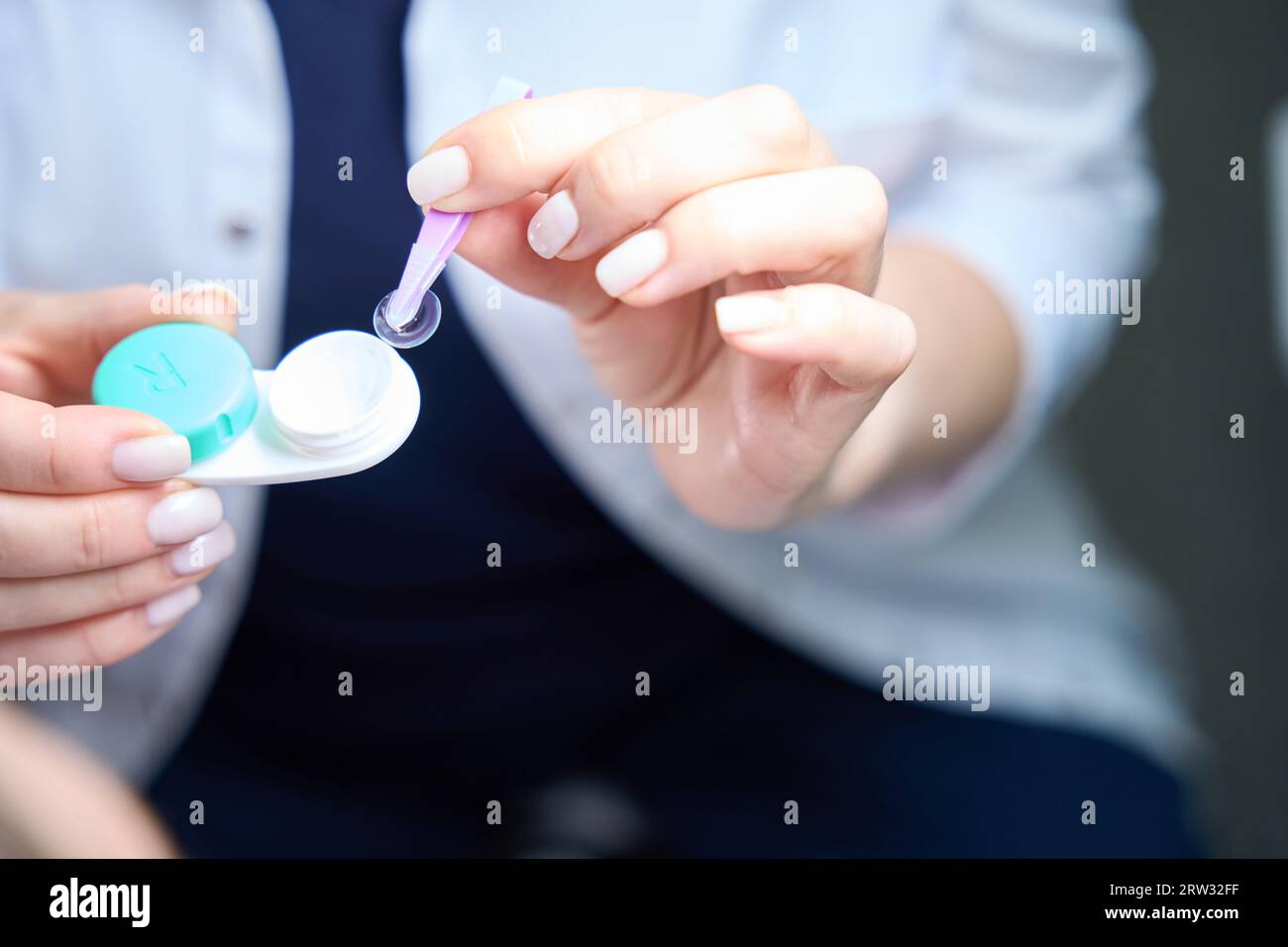Female optometrist showing corrective lenses in front of camera Stock ...