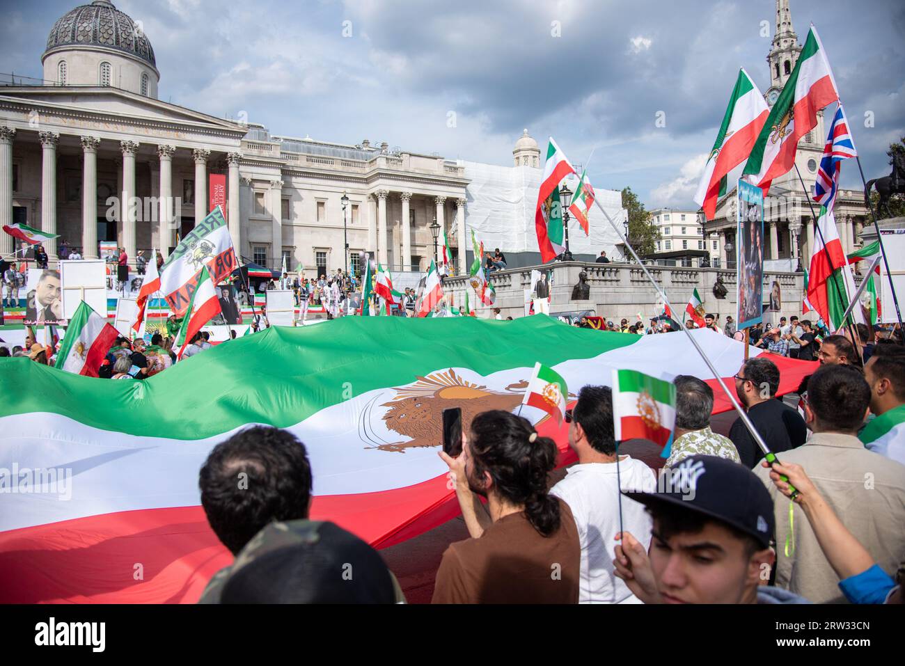 London, UK. 16th Sep, 2023. Protestors wave a large Iranian flag at ...