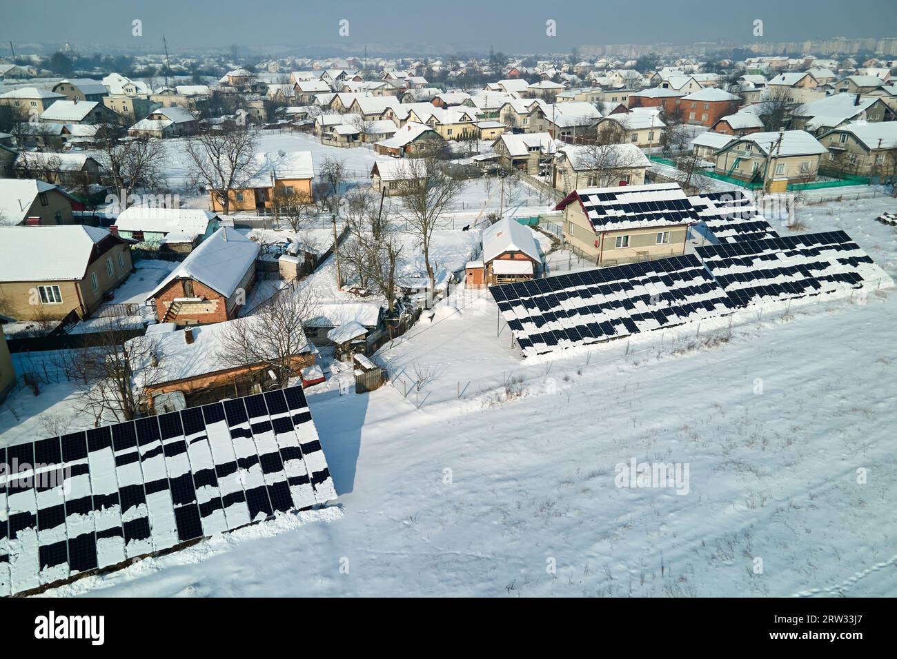Aerial view of snow melting from covered solar photovoltaic panels ...
