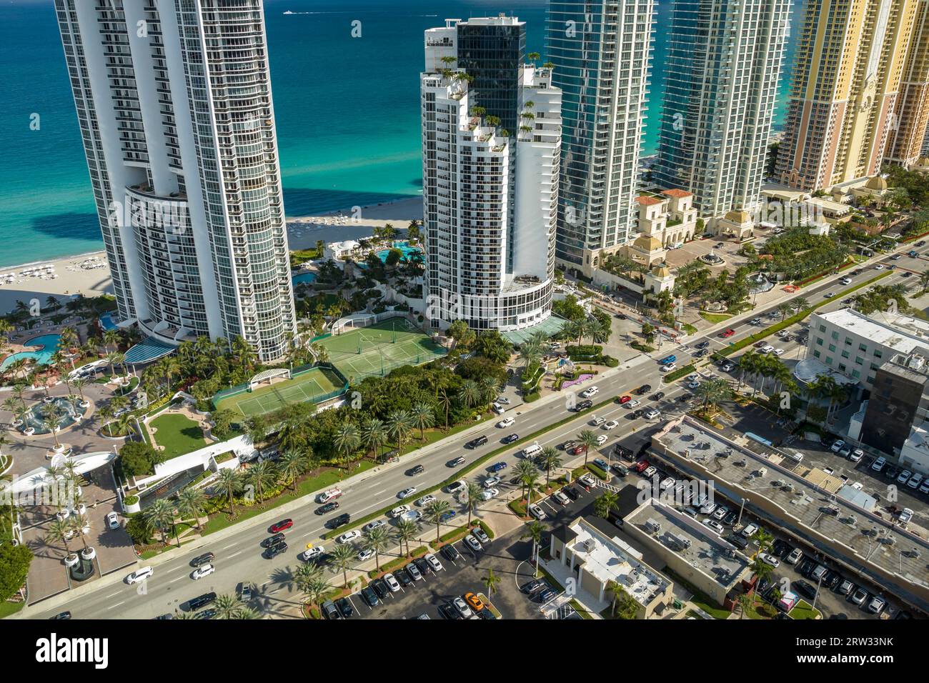 Aerial view of Sunny Isles Beach city with congested street traffic and ...