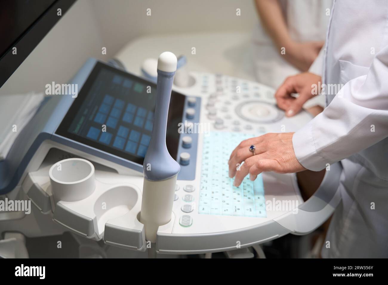 Doctor sets up ultrasound machine for ultrasound of the uterus Stock ...