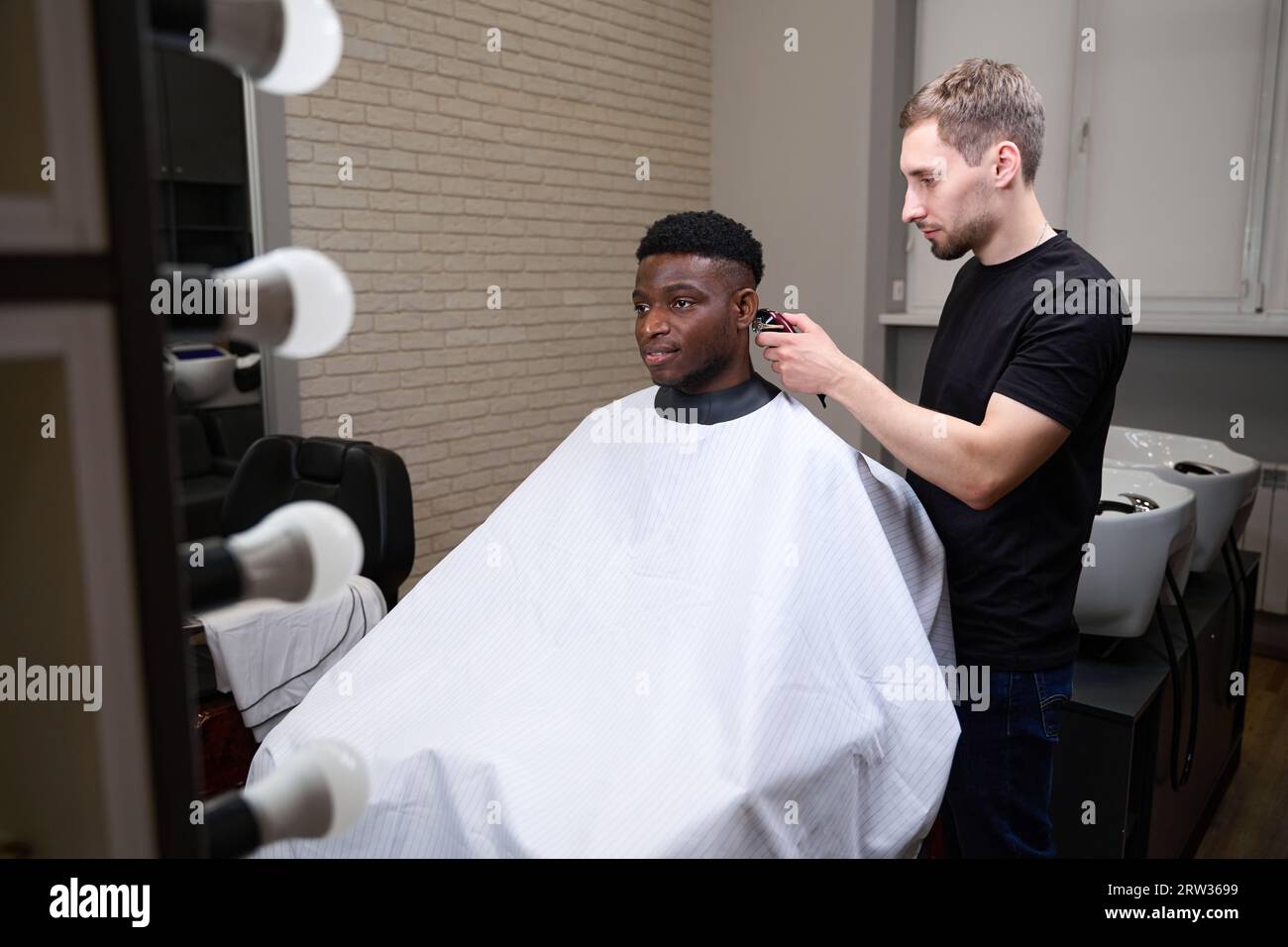 Young guy gets haircut hair hi-res stock photography and images - Alamy