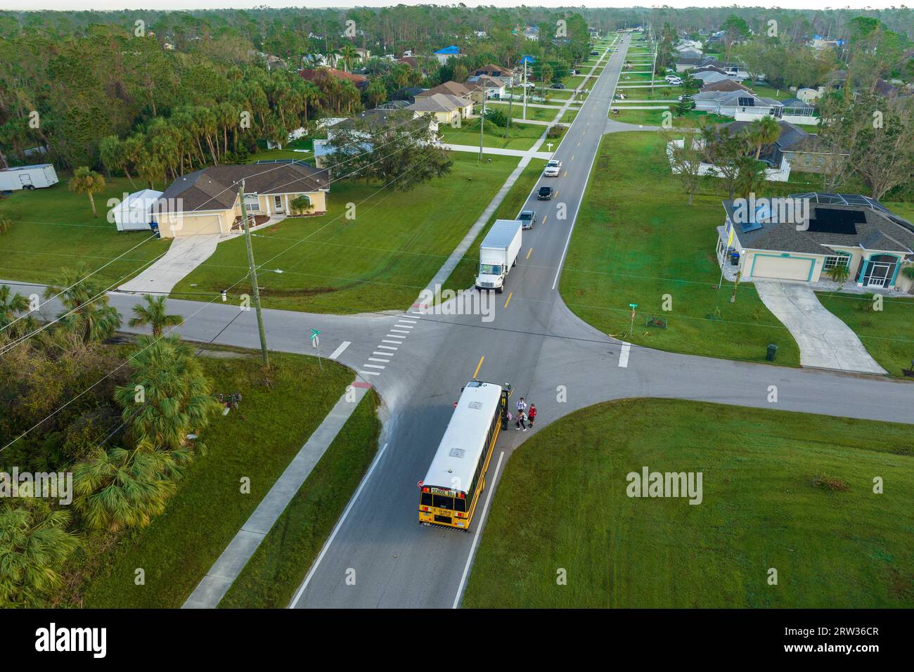 Top view of classical american yellow school bus picking up kids at ...