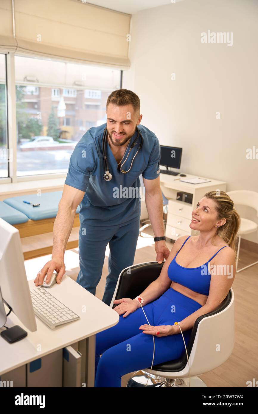Physiotherapy specialist exlplaining to woman patient how the stress ...