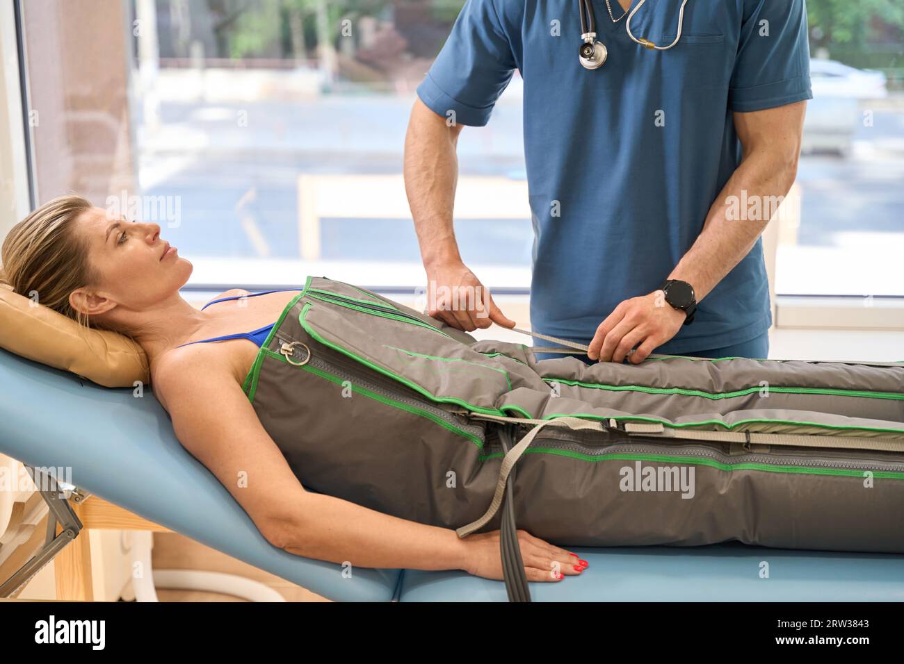 Adult woman attending pressotherapy procedure, stimulate the lymphatic ...