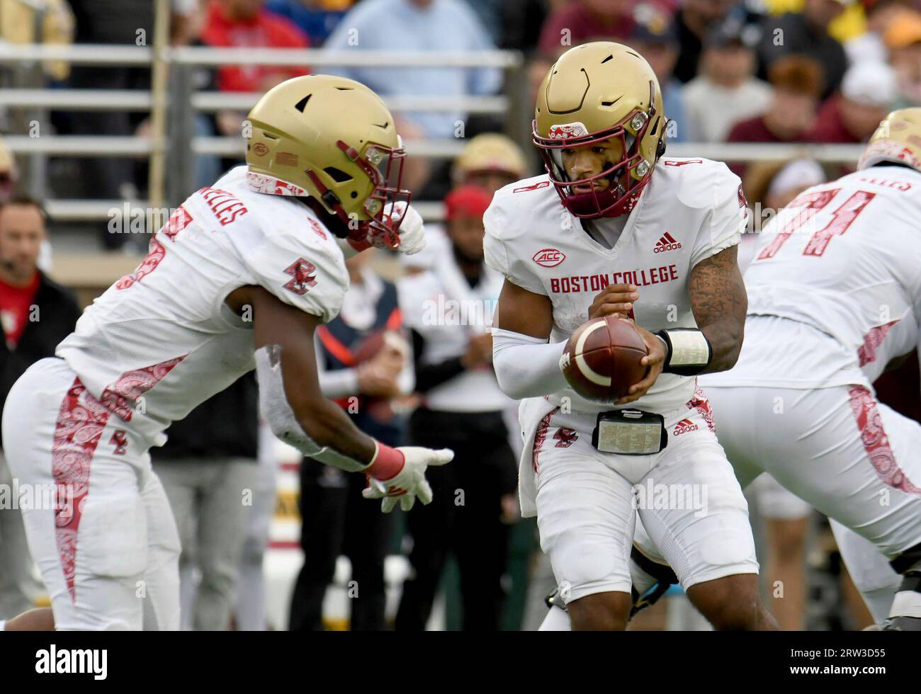 Boston College quarterback Thomas Castellanos (1) hands the ball of to ...