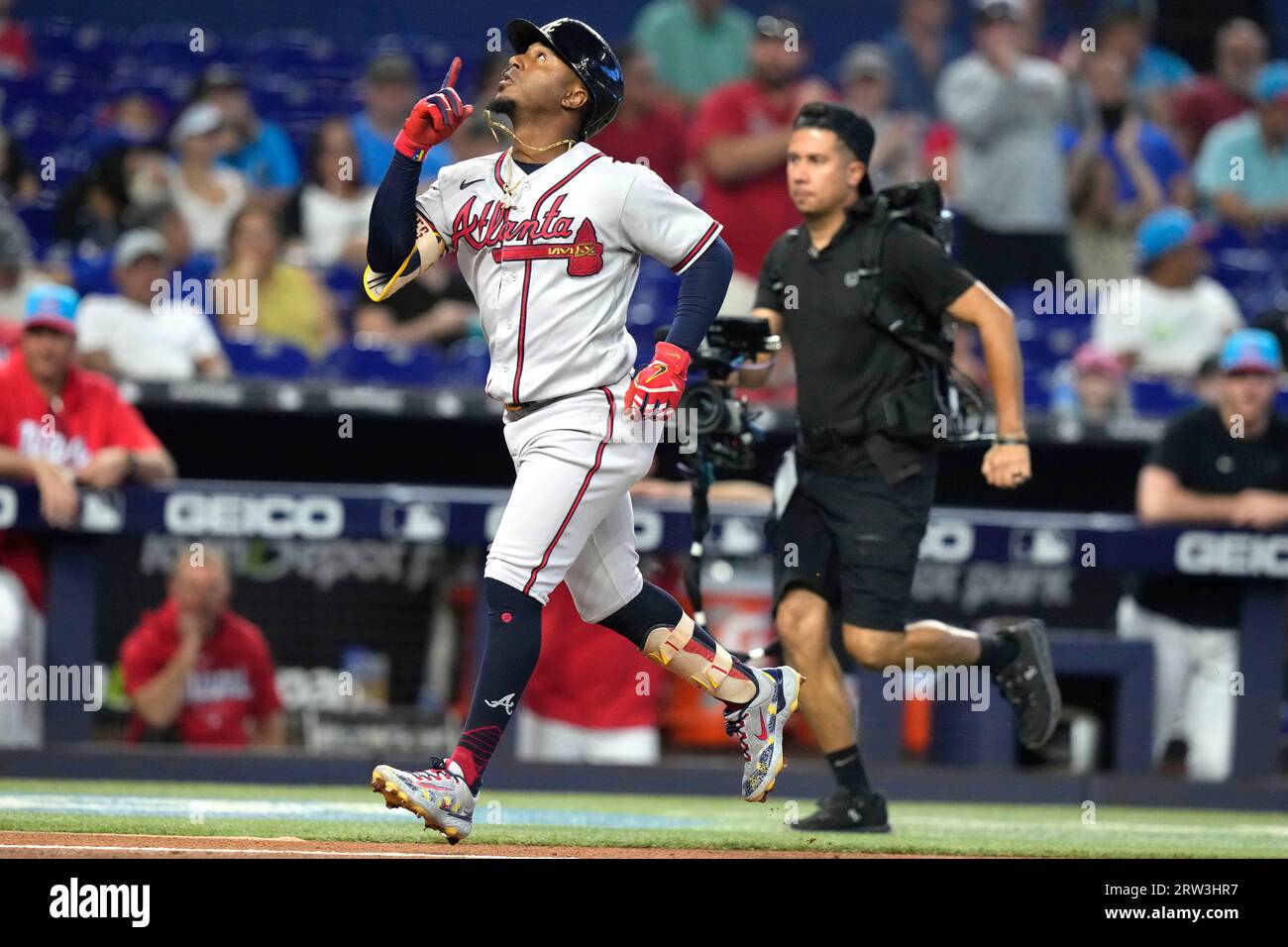 Atlanta Braves' Ozzie Albies reacts after hitting a two-run home run during the first inning of ...