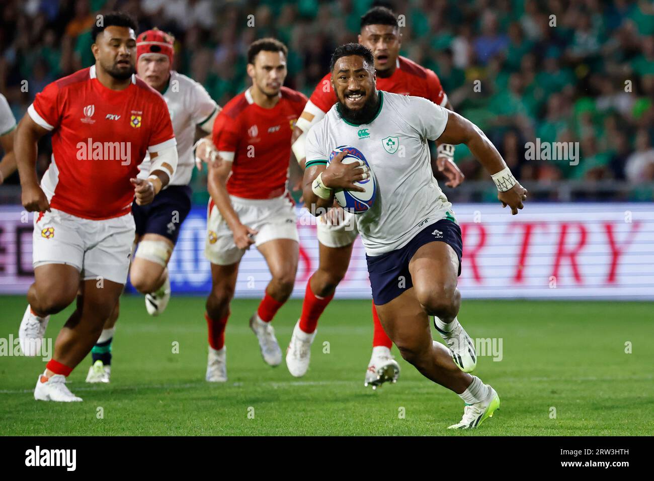 Ireland's Bundee Aki runs with the ball before scoring a try during the ...