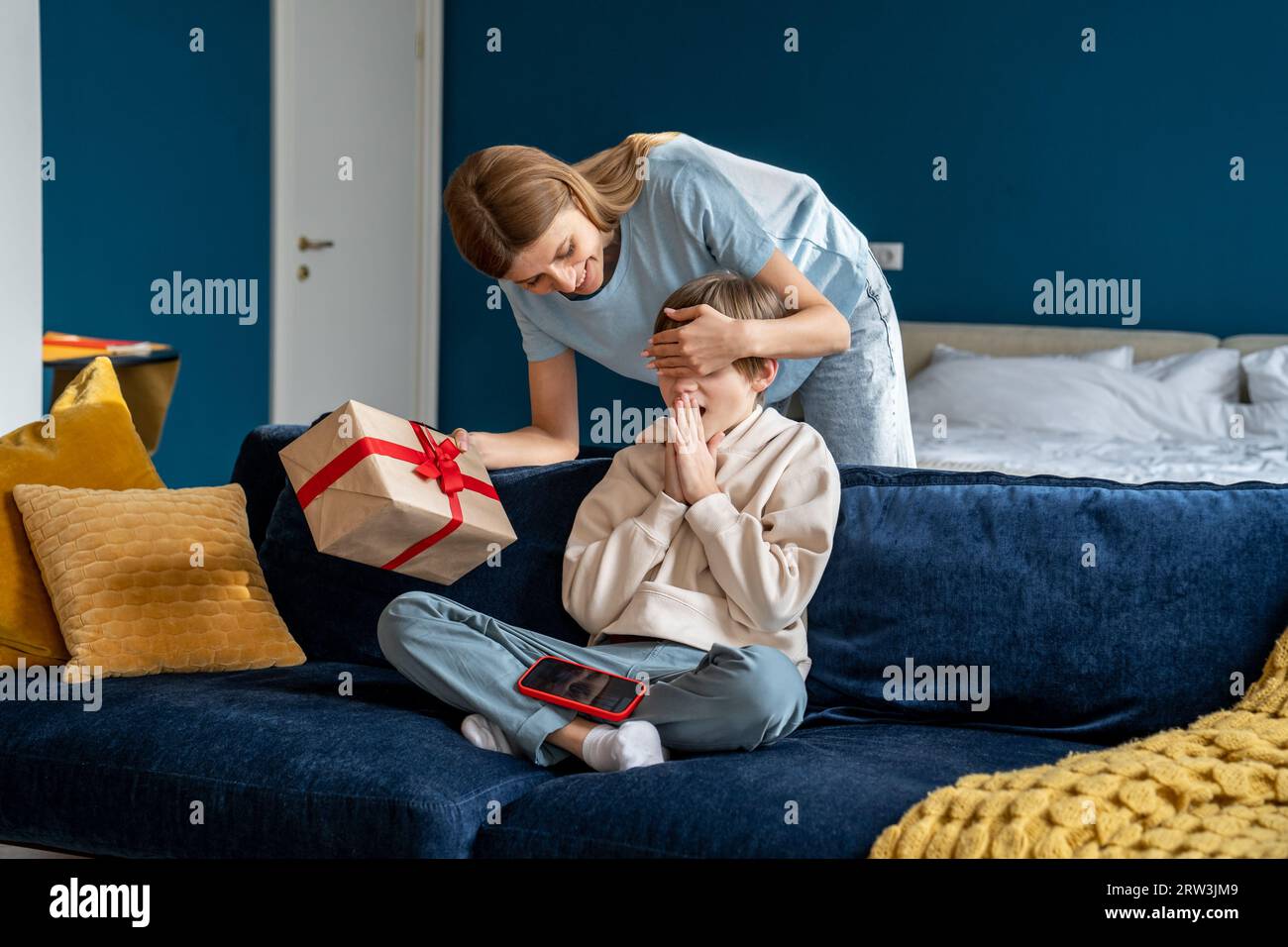 Young happy loving mother closing eyes of child son congratulating ...