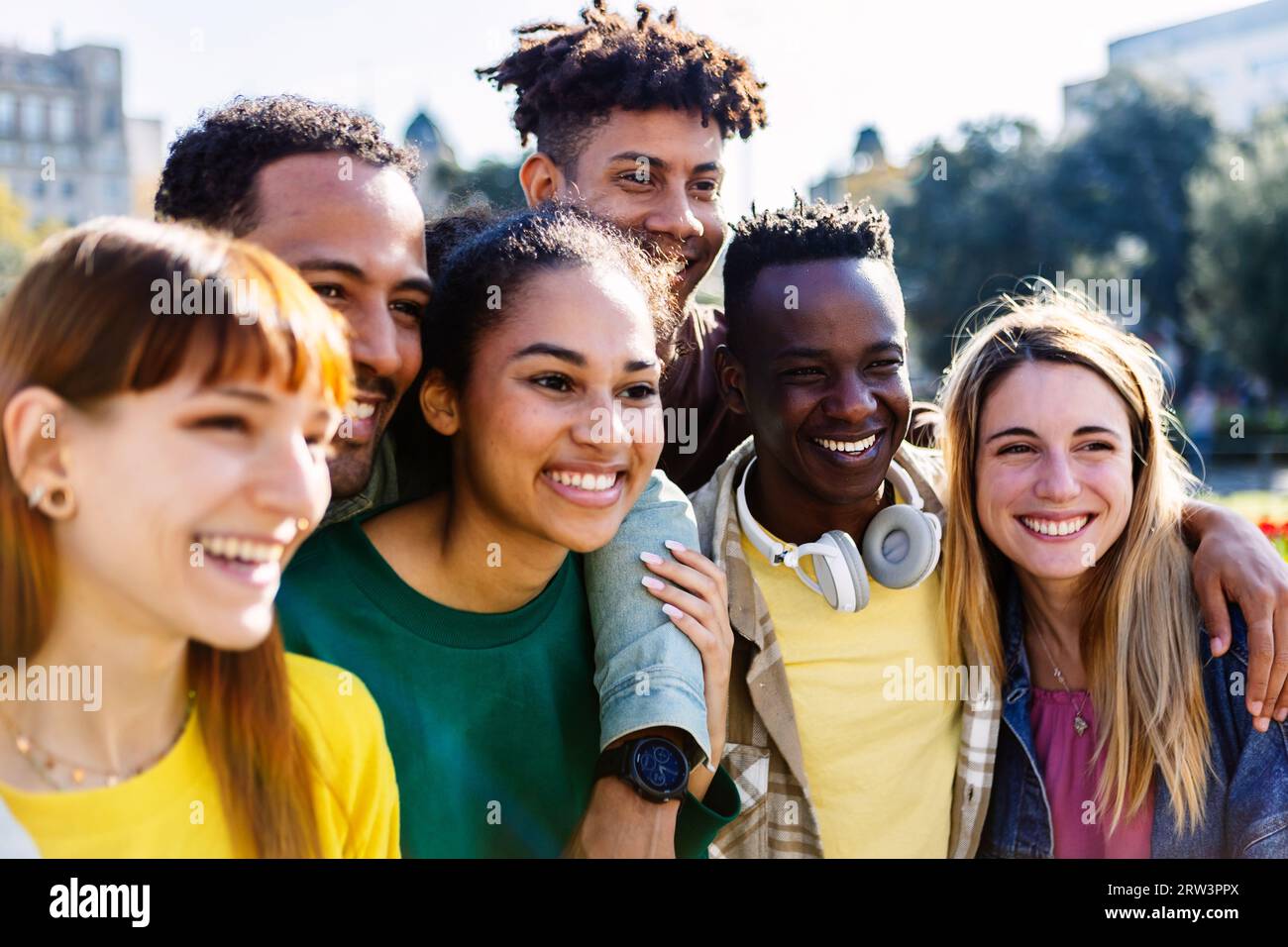 United group of multiracial young friends standing together outdoors ...