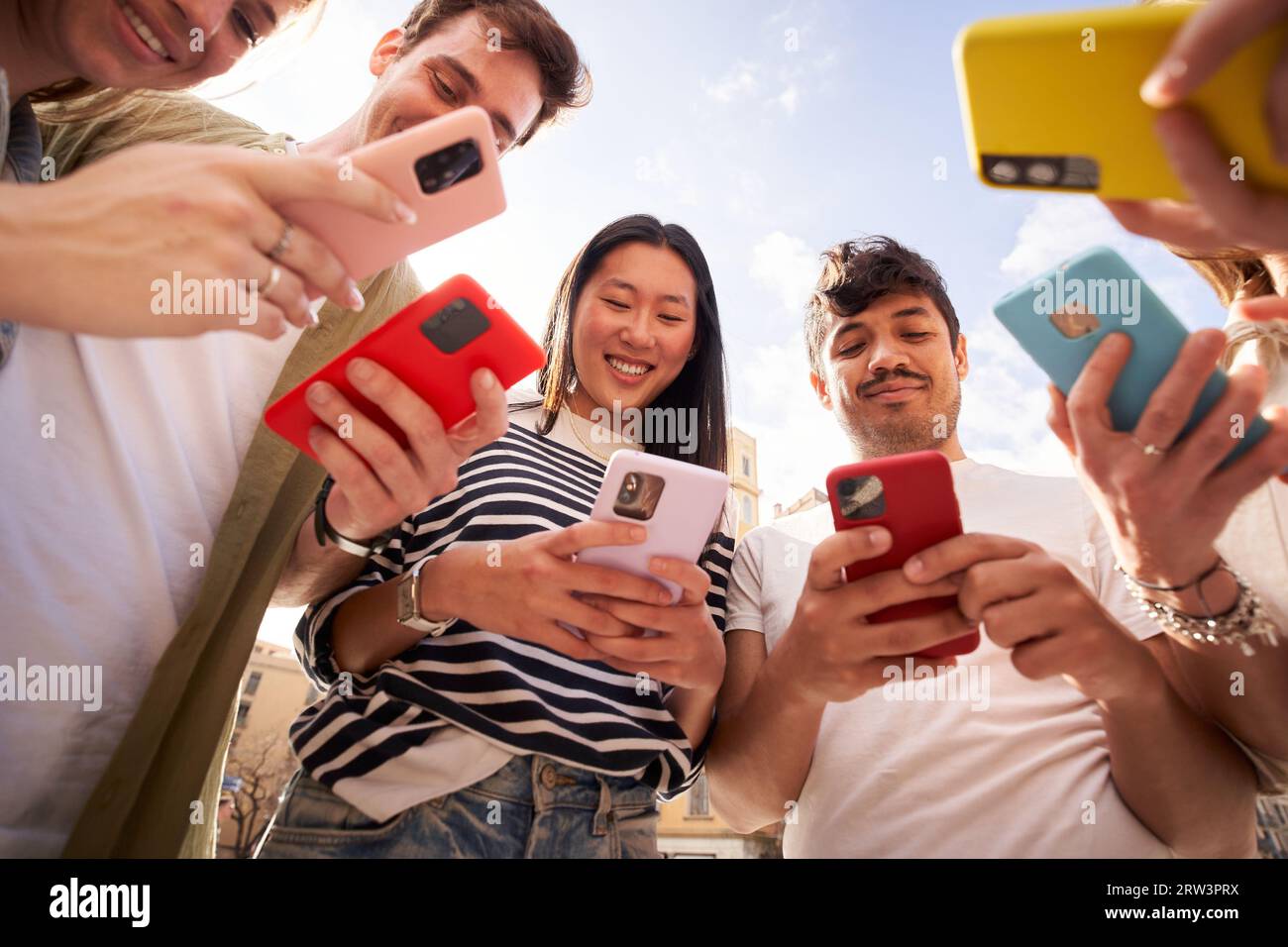 Low angle view multiracial group young generation z in circle using ...