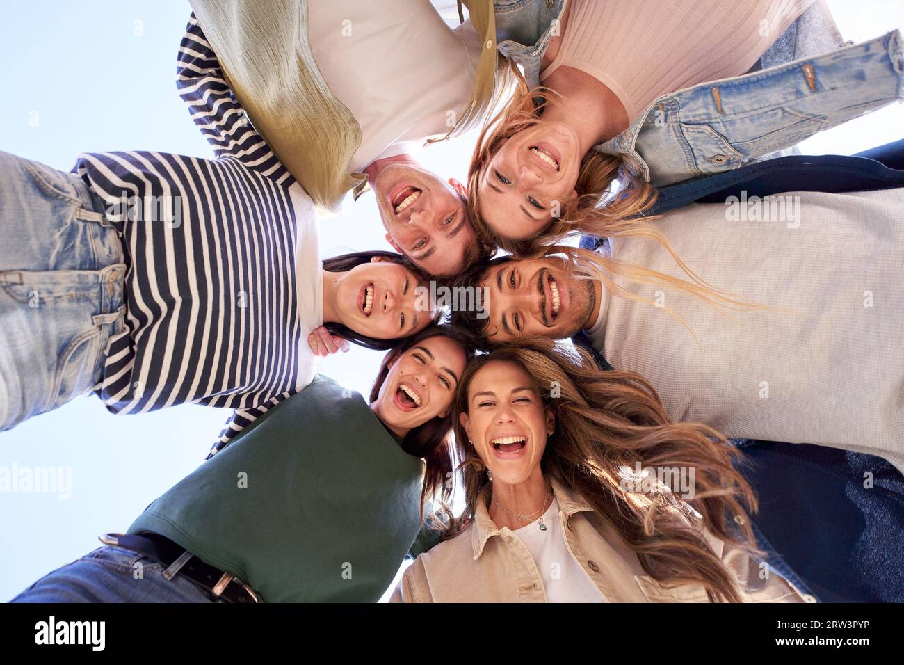 Multiracial group young beautiful happy people standing in circle and ...