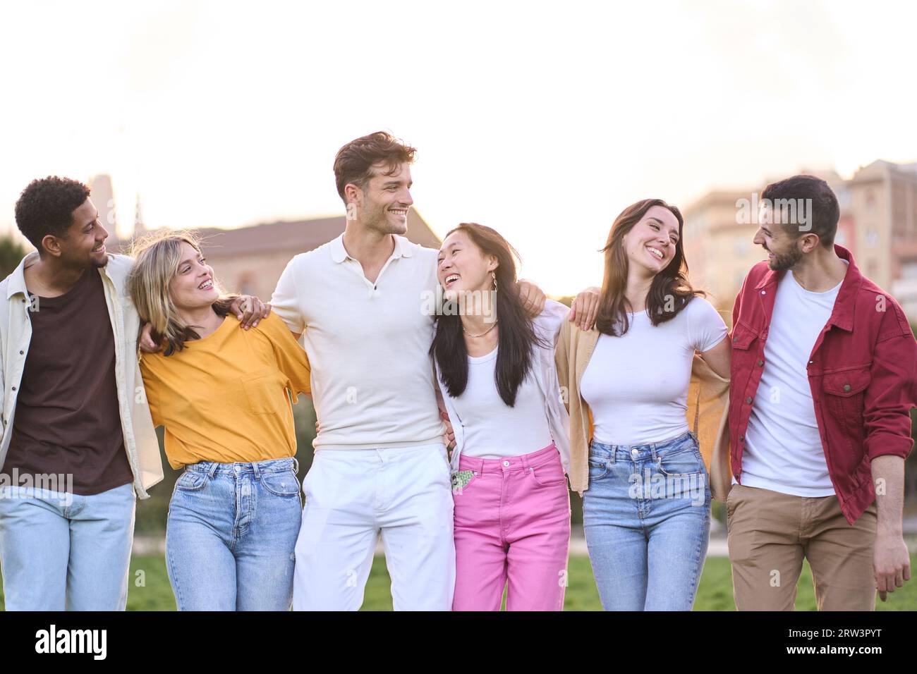 Multirracial group of cheerful young friends together at the park ...