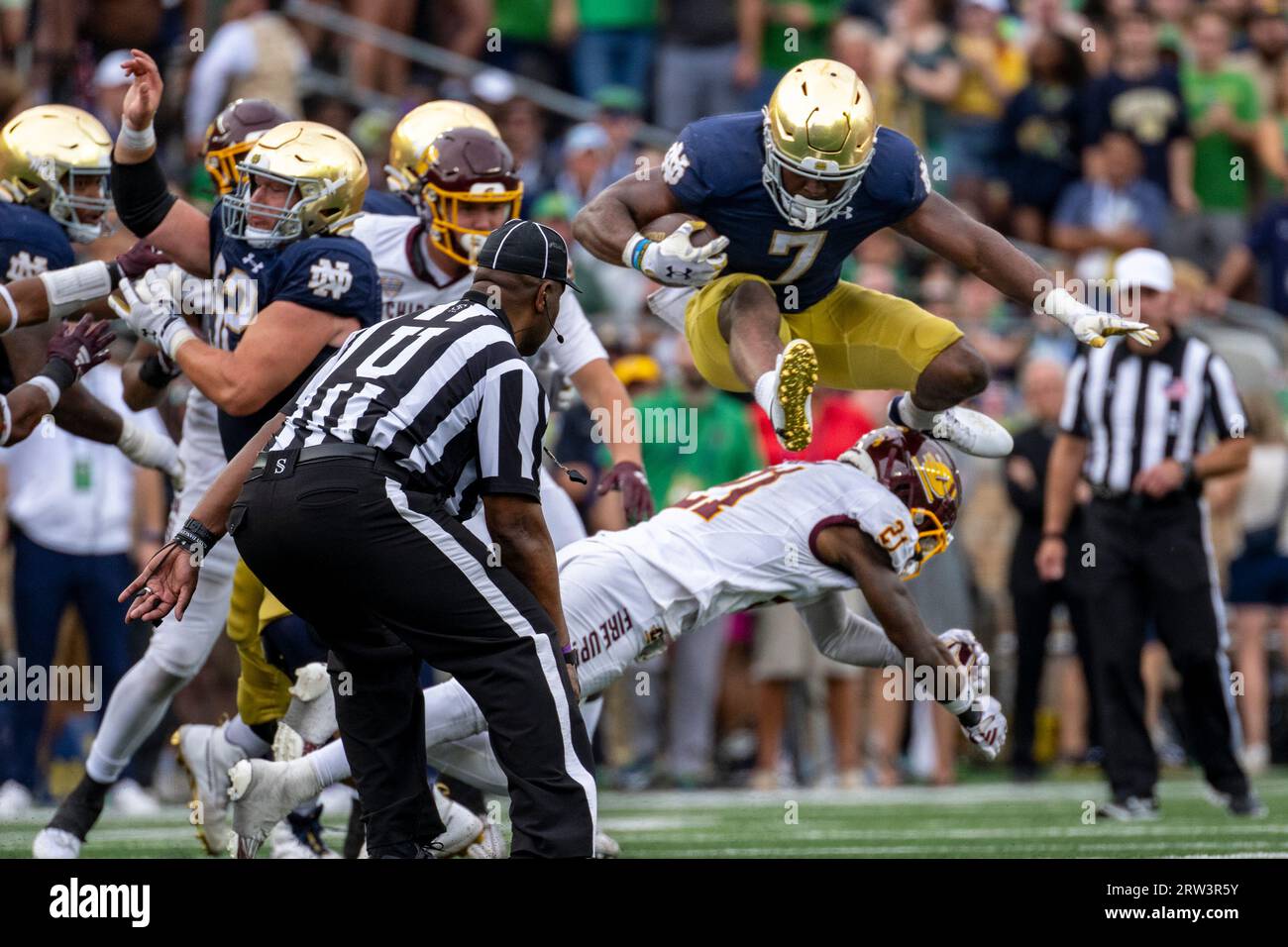 Notre Dame running back Audric Estime (7) leaps over Central Michigan ...