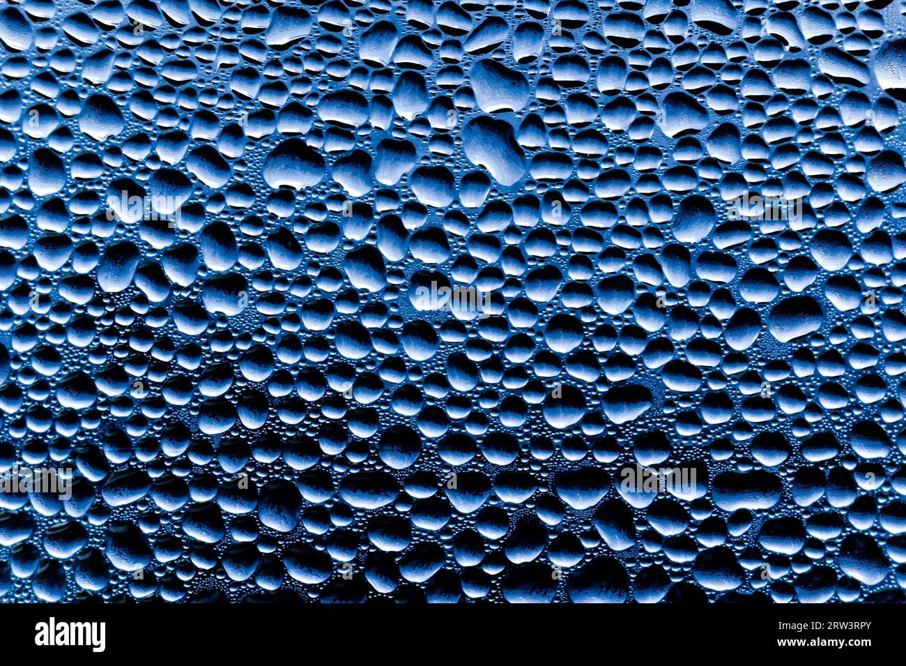 Blue abstract background, many drops on a glass Stock Photo - Alamy