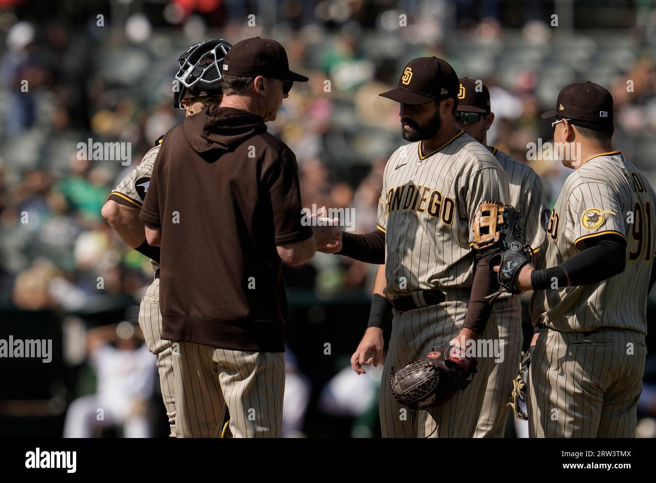 San Diego Padres pitcher Matt Waldron, third from right, hands the ball ...