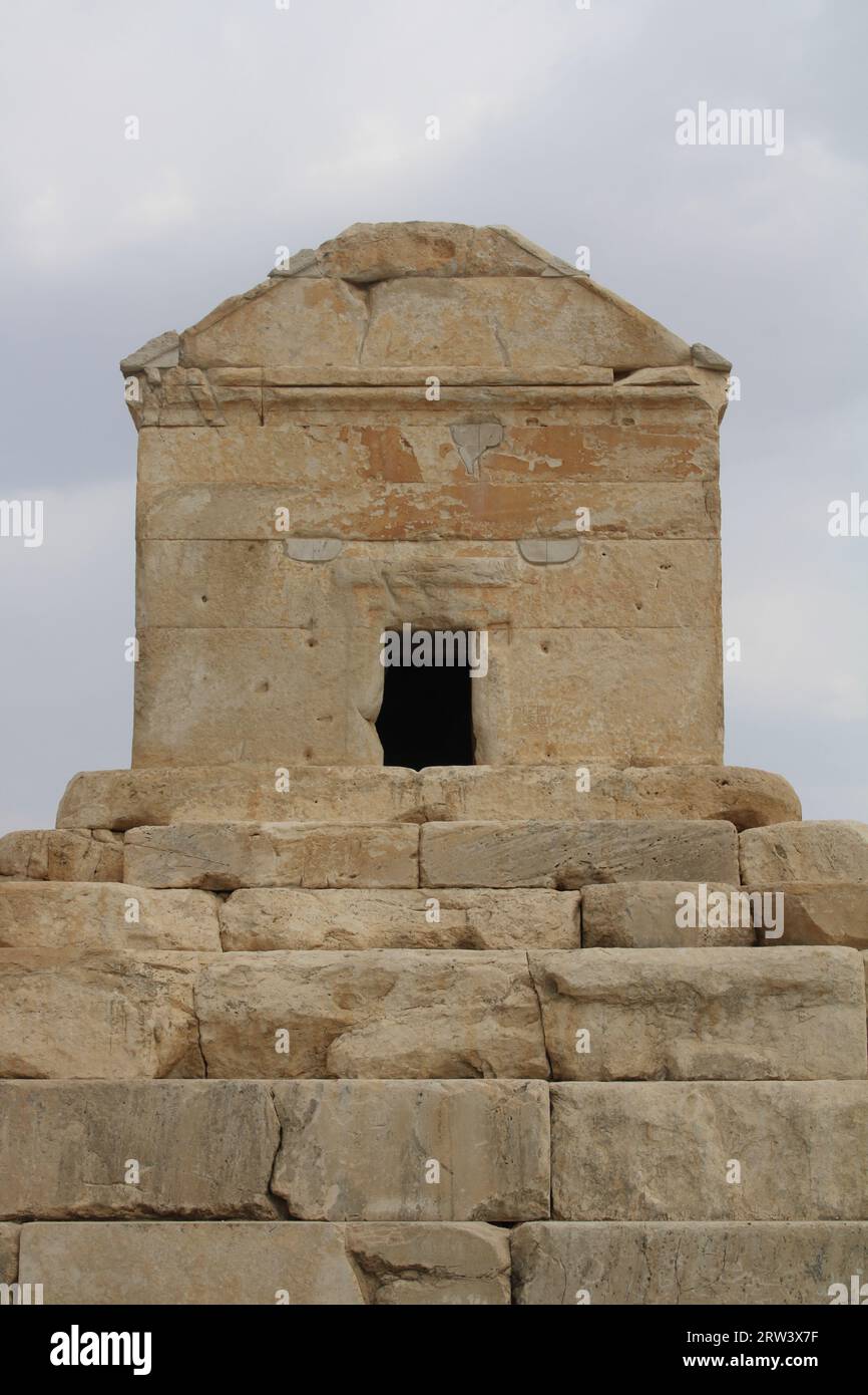 A majestic stone structure with an open archway stands atop a rocky ...
