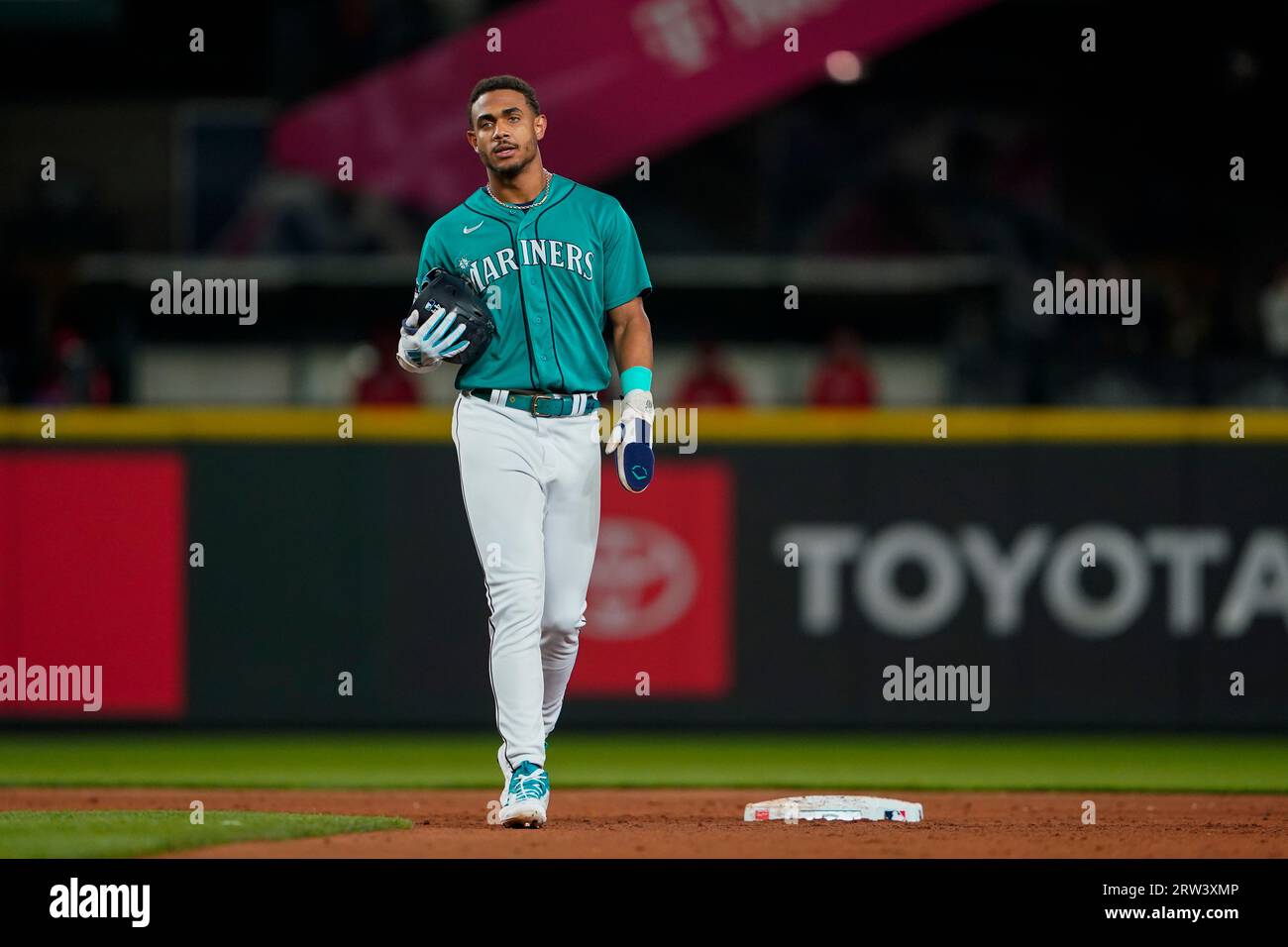 Seattle Mariners' Julio Rodriguez holds his helmet after an inning in a ...