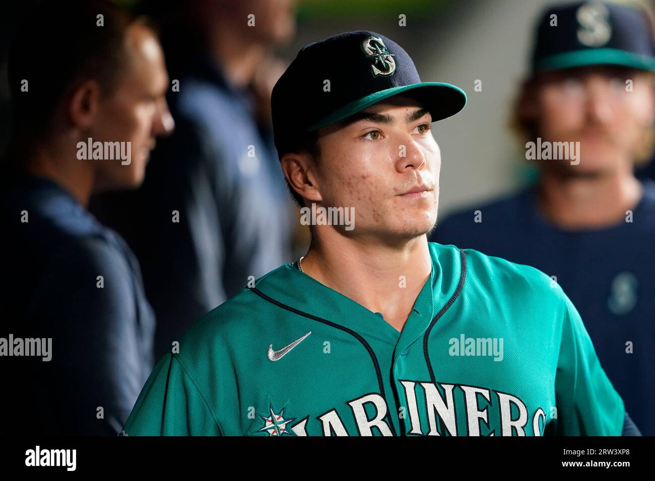 Seattle Mariners starting pitcher Bryan Woo walks in the dugout after ...
