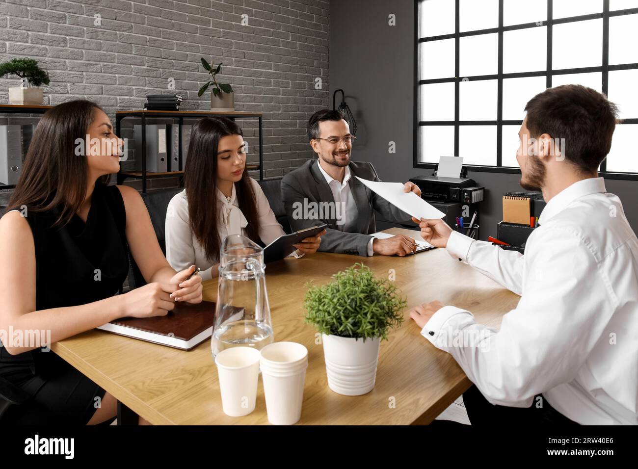 Human resources commission interviewing male applicant in office Stock ...