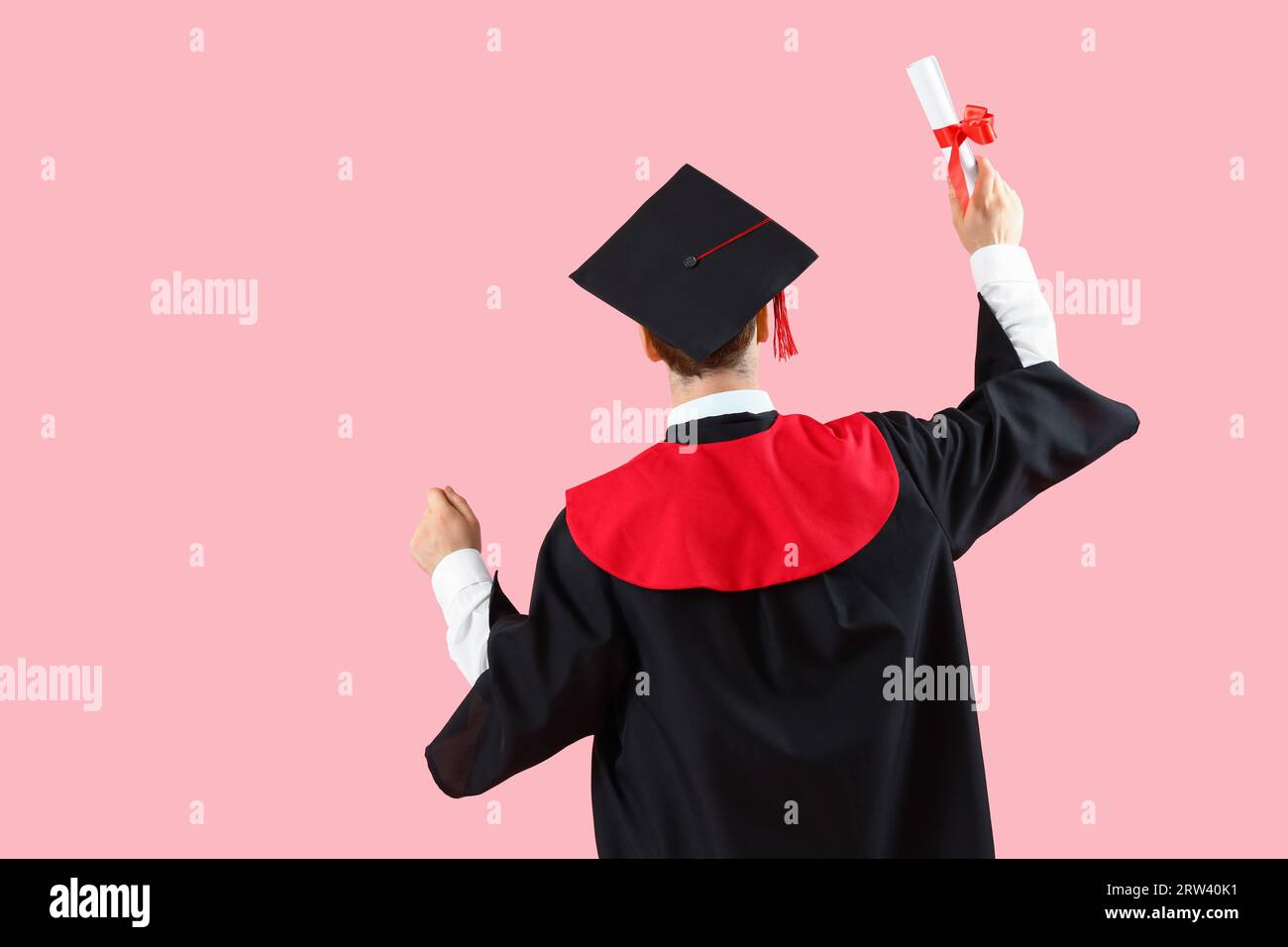 Male graduate student with diploma on pink background, back view Stock ...