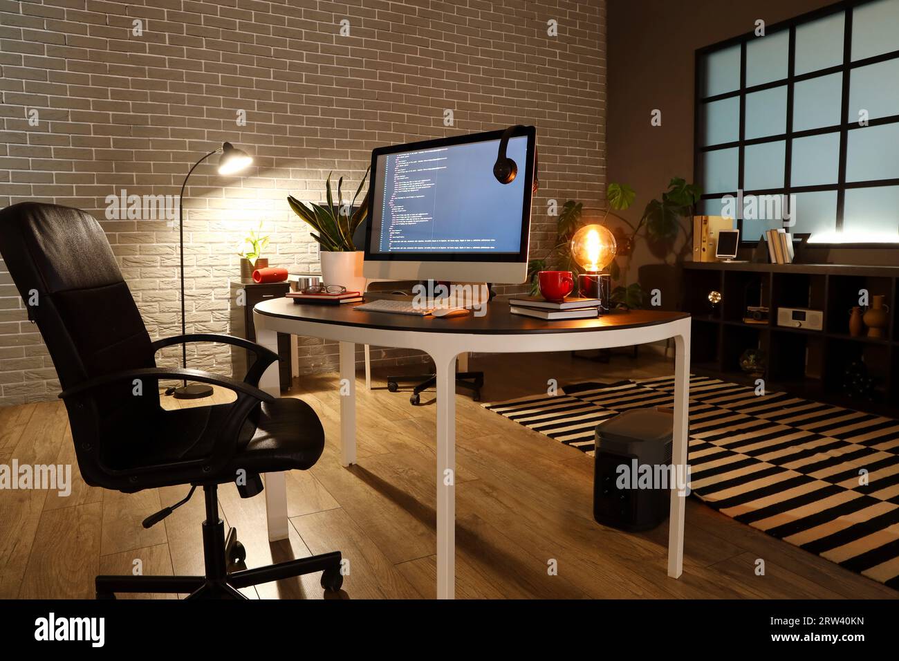 Programmer's workplace with computer in interior of dark office Stock ...