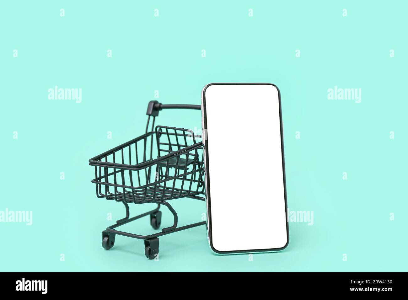 Small shopping cart with mobile phone on turquoise background Stock ...
