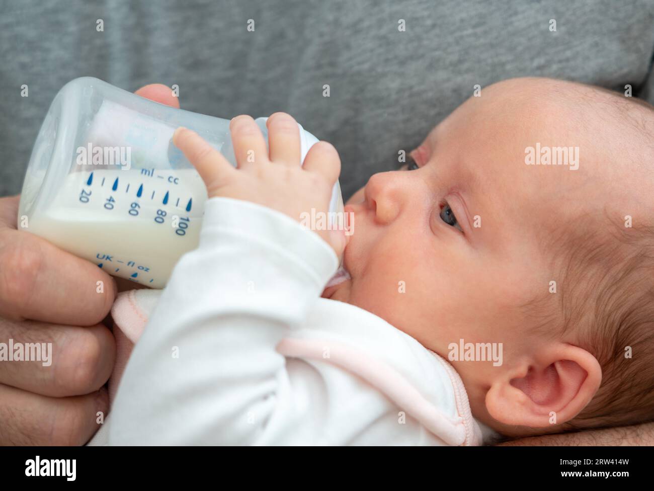 Man's journey into fatherhood, feeding his newborn baby formula from a ...