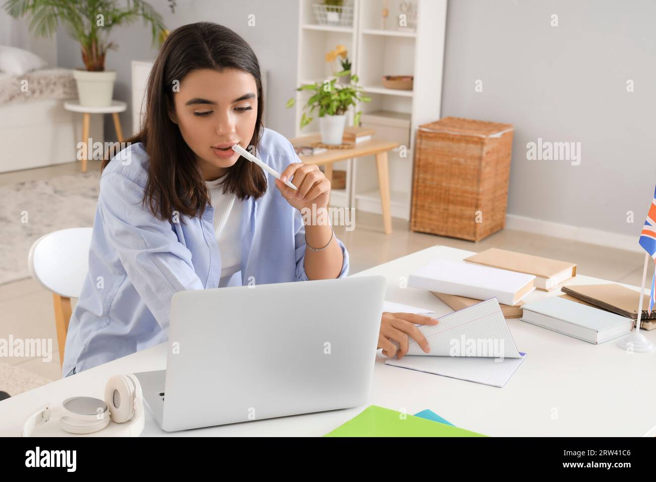 Young woman learning English language online at home Stock Photo - Alamy
