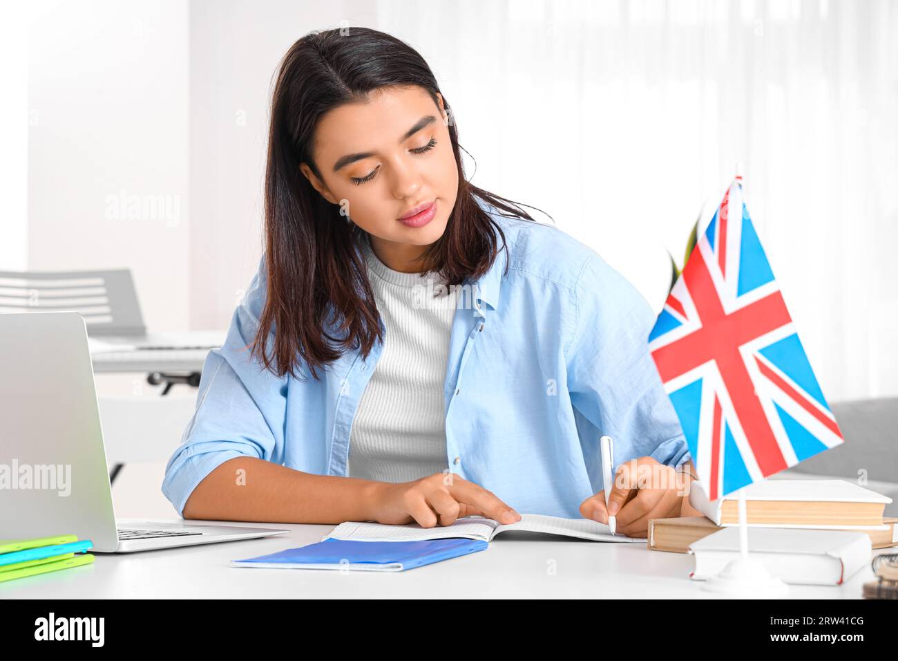 Young woman learning English language online at home Stock Photo - Alamy